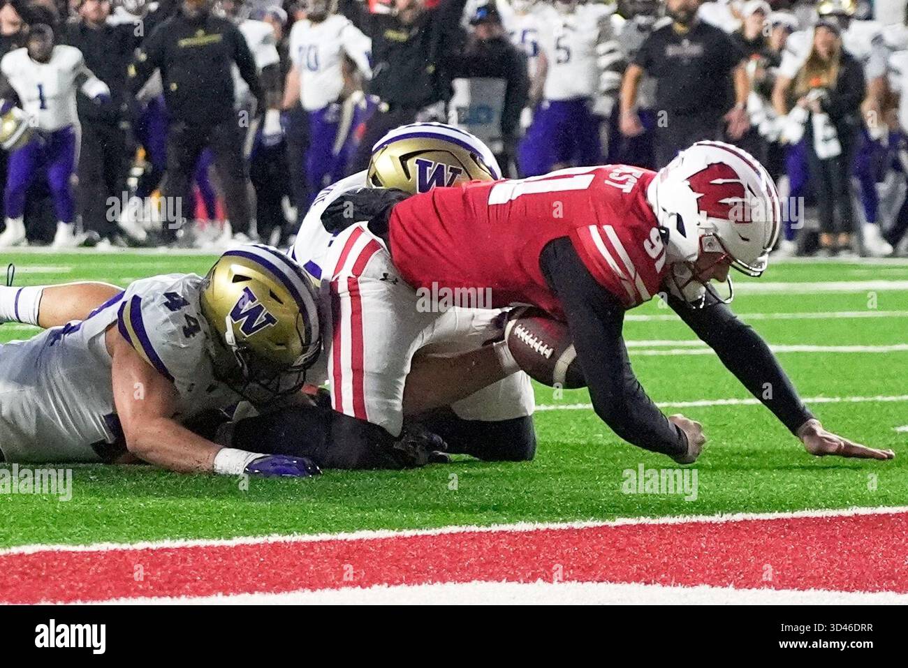 Wisconsin kicker Sean West recovers the ball after having a punt ...
