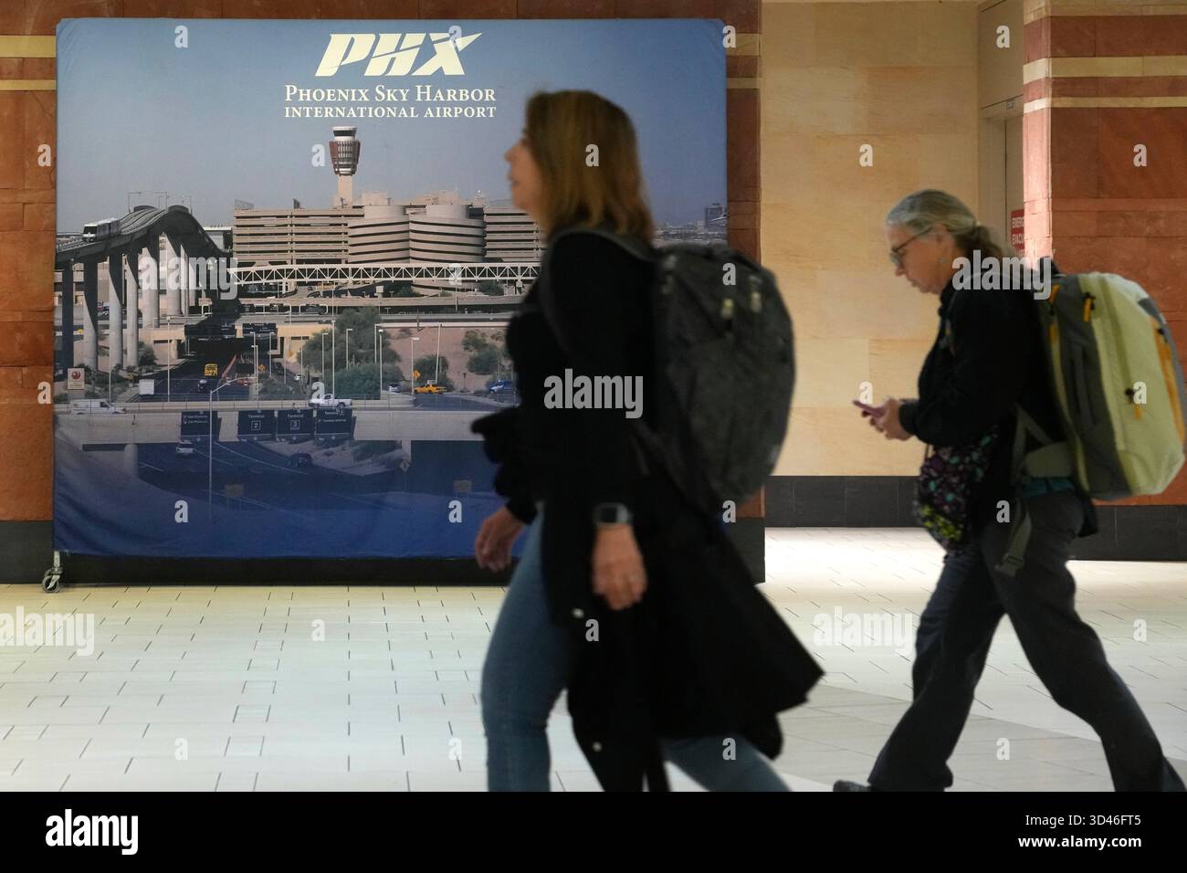 Passengers walk through terminal 4 at Phoenix Sky Harbor International ...