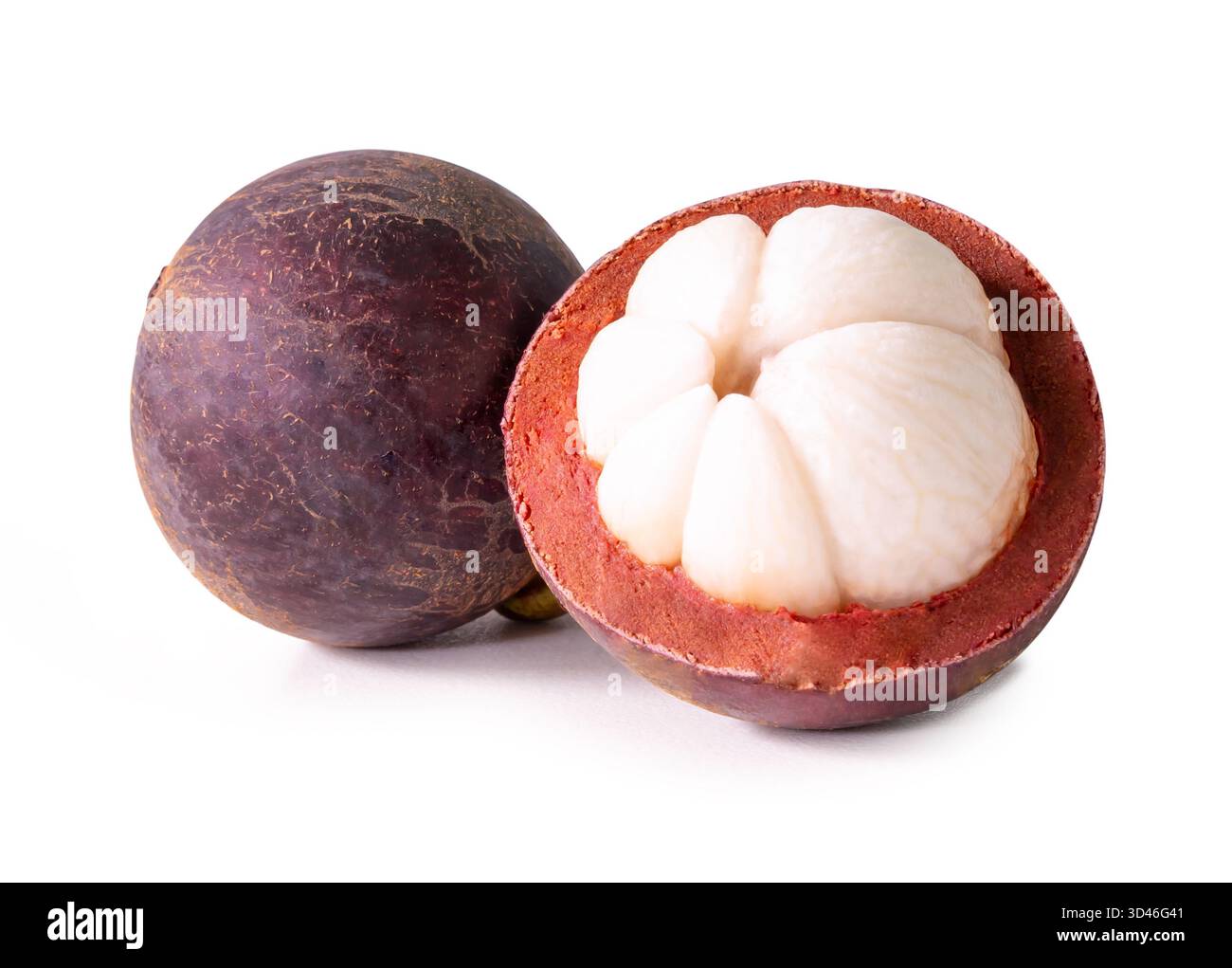One ripe mangosteen with peel and one unpeeled mangosteen in half are ...