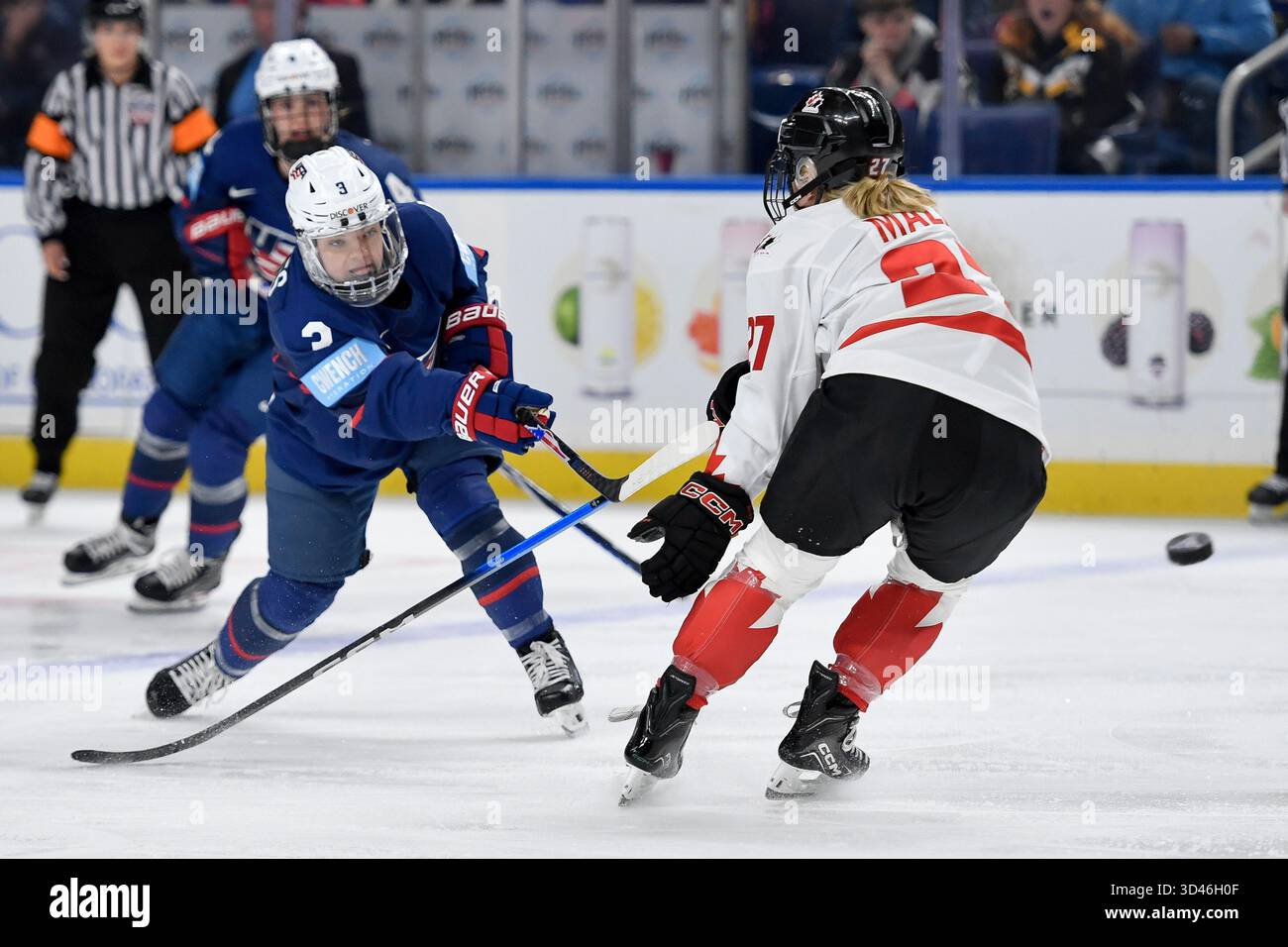 United States defensewoman Cayla Barnes, left, clears the puck past ...