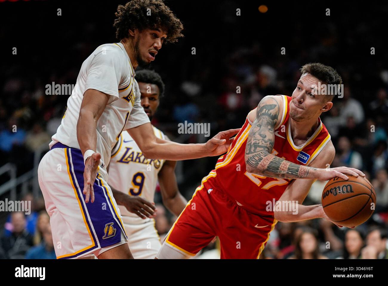 Atlanta Hawks guard Vit Krejci (27) saves the ball from Los Angeles Lakers center Jaxson Hayes ...