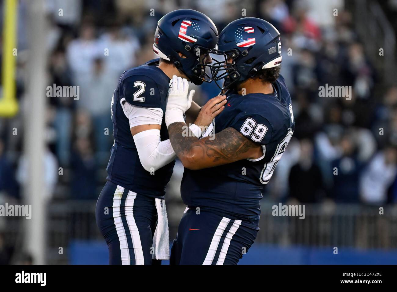 UConn quarterback Joe Fagnano (2) and UConn offensive lineman Ty Chan ...