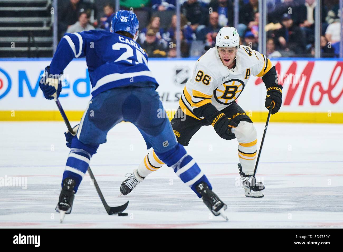 Boston Bruins' David Pastrnak (88) can't get to the puck as Toronto ...