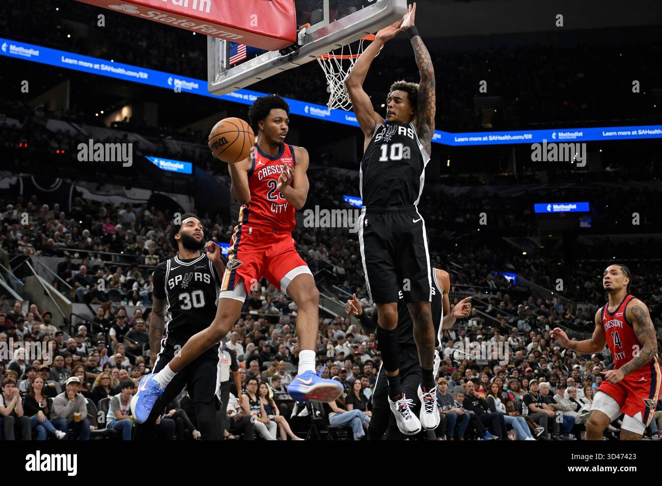 New Orleans Pelicans forward Trey Murphy III looks to pass as he is guarded by San Antonio Spurs ...