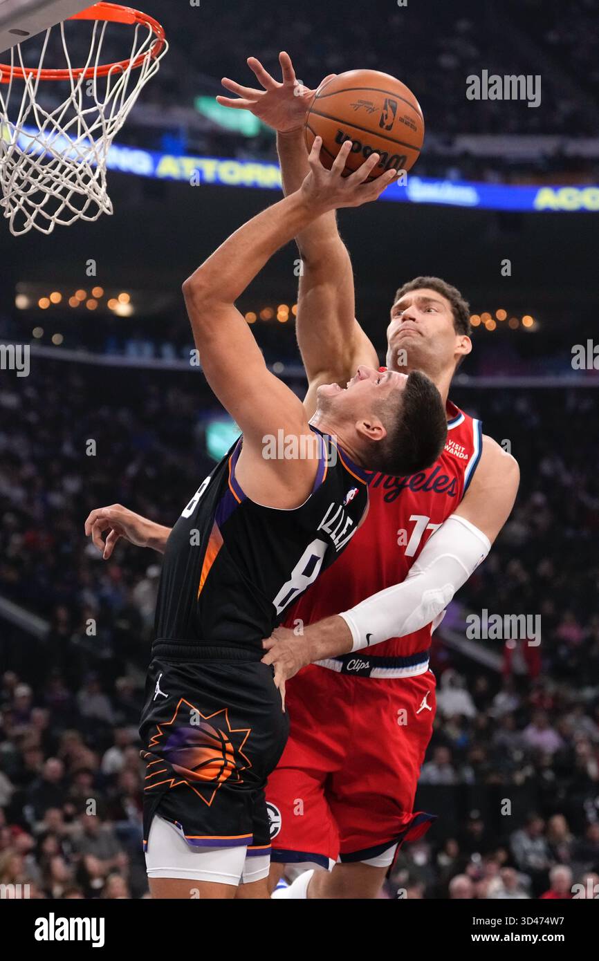 Phoenix Suns guard Grayson Allen, left, shoots as Los Angeles Clippers ...