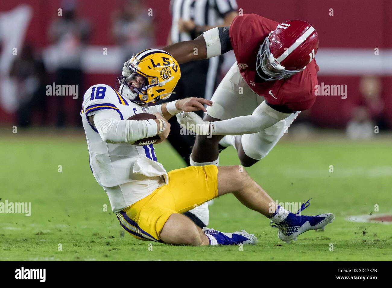 Alabama defensive lineman Jordan Renaud (11) tears the helmet off of ...