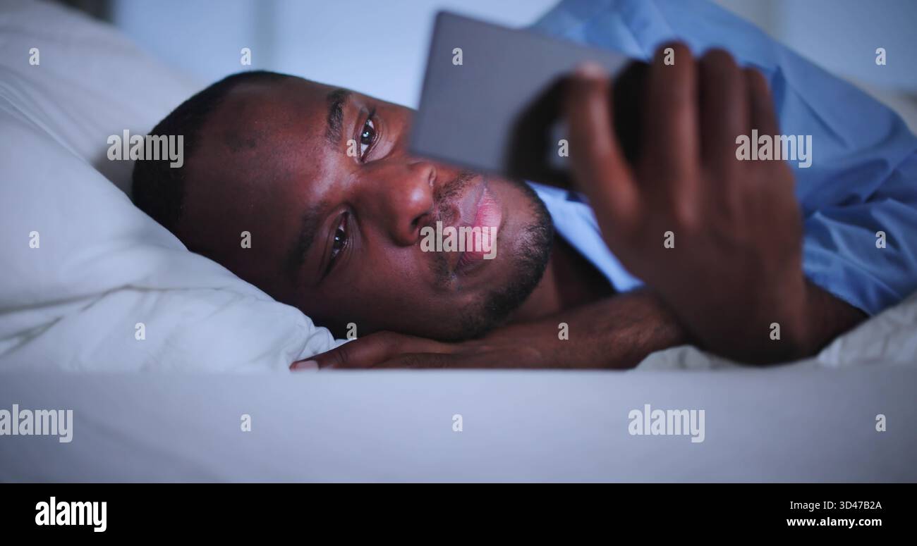 The Late Night Binge Watching: African Man Glued To Phone In Bed - In ...