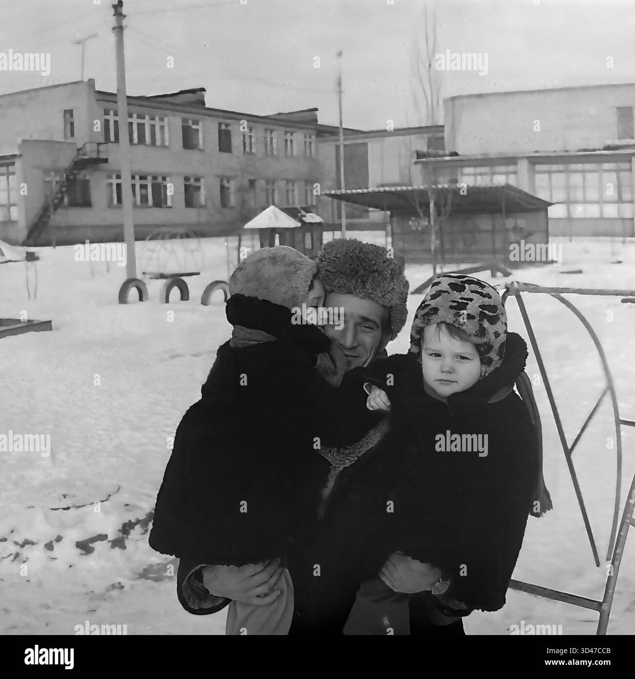 An archival photo from the 1980s shows a father and his two small ...