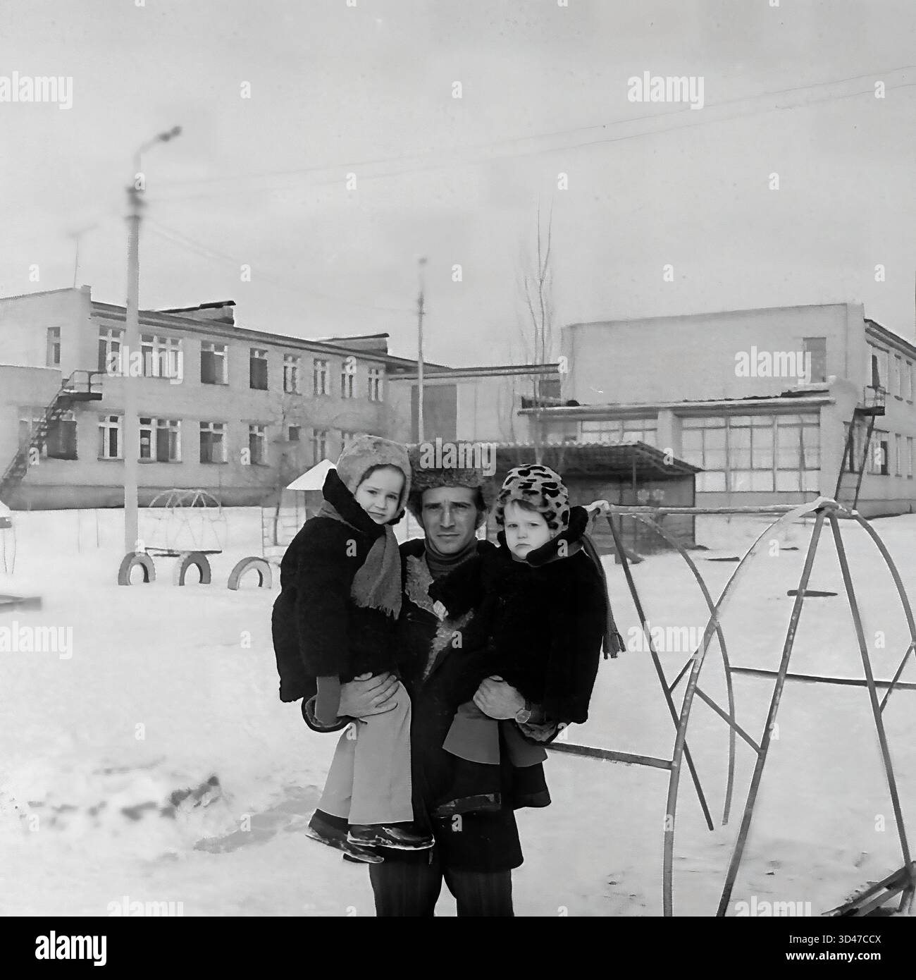 An archival photo from the 1980s shows a father and his two small ...