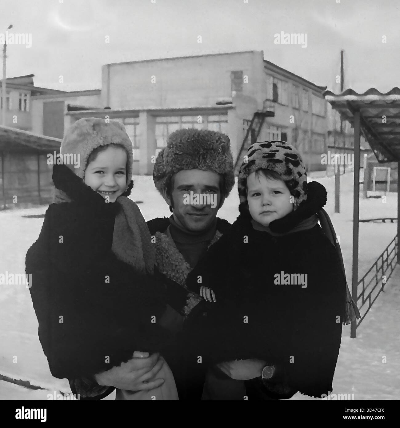 An archival photo from the 1980s shows a father and his two small ...