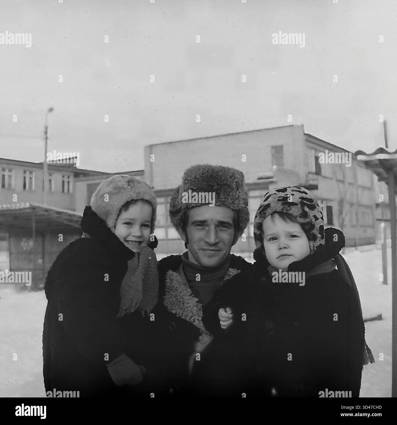 An archival photo from the 1980s shows a father and his two small ...