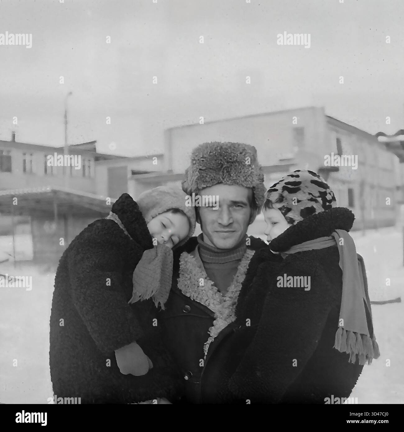 An archival photo from the 1980s shows a father and his two small ...