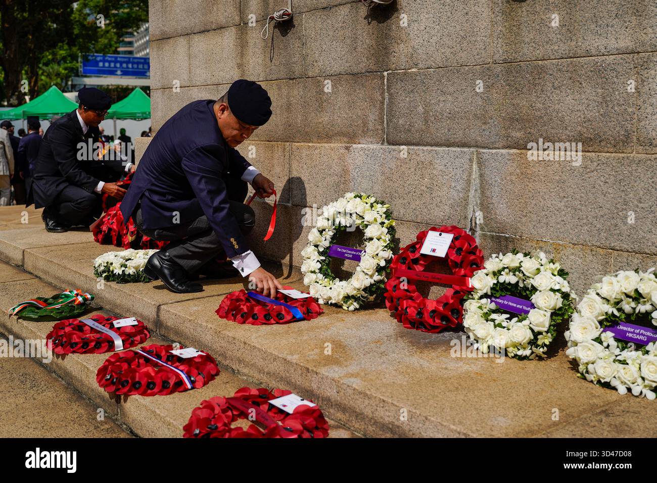 Workers moving Remembrance flower circles at the Cenotaph during an ...