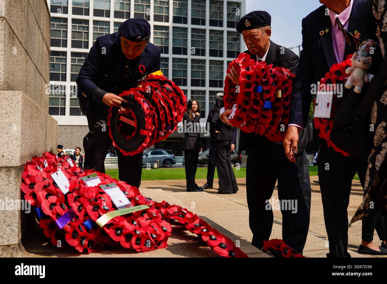 Workers moving Remembrance flower circles at the Cenotaph during an ...