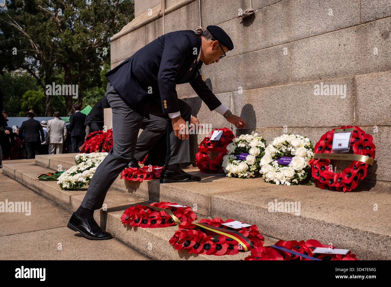 Workers moving Remembrance flower circles at the Cenotaph during an ...