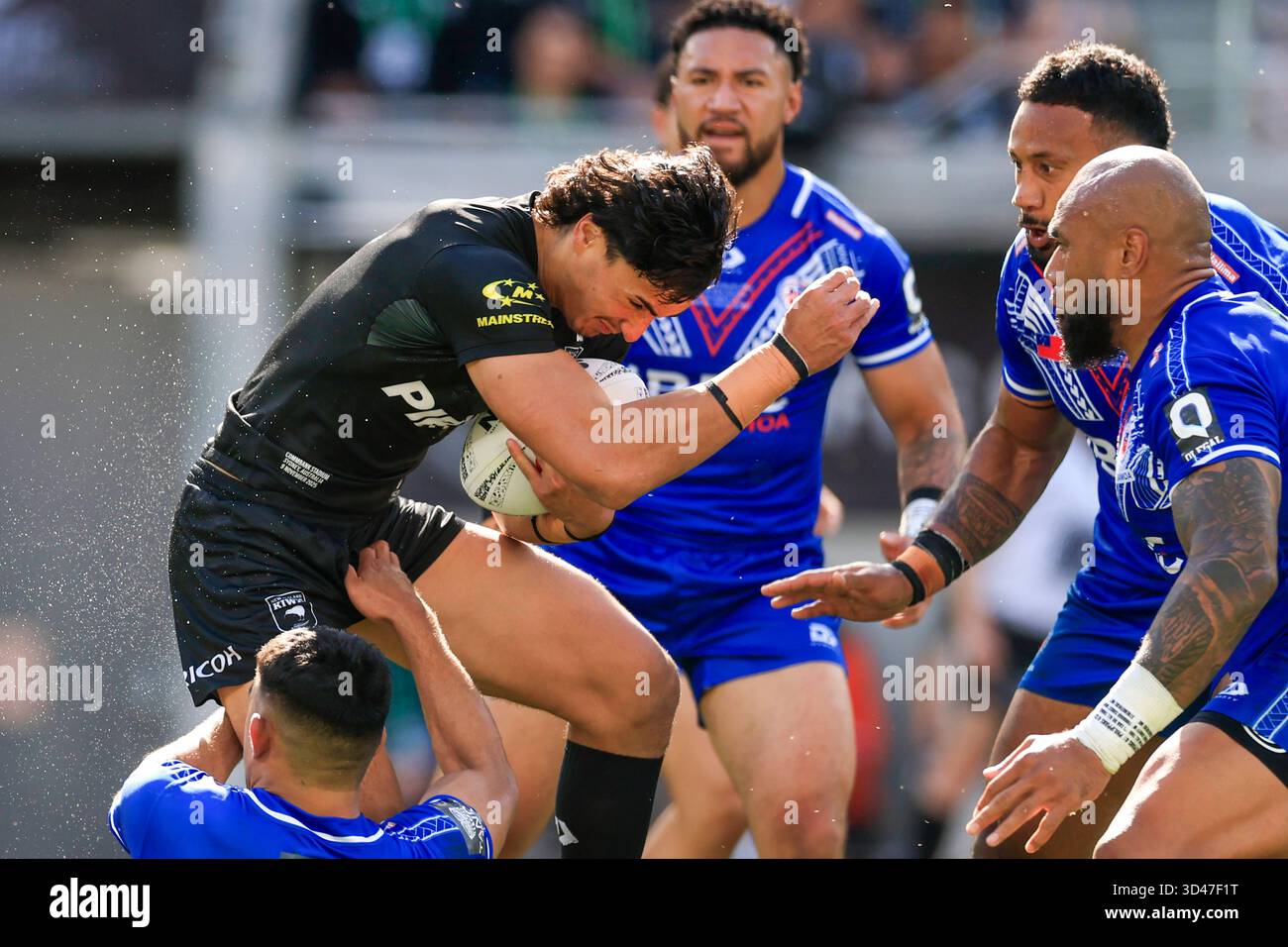 Casey McLean of the Kiwis is tackled during the rugby league Pacific ...