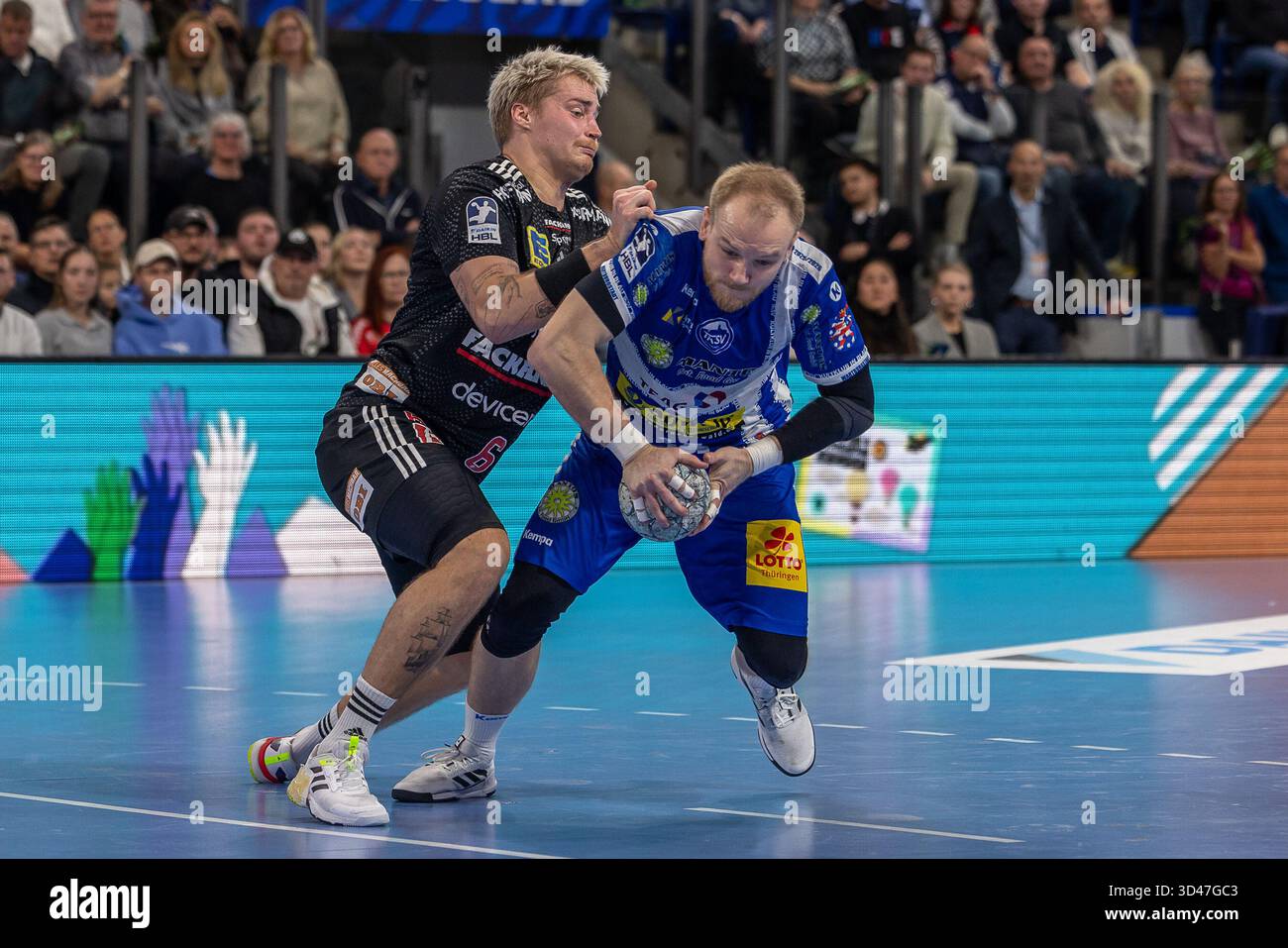 Peter Walz (ThSV Eisenach, #14) in a duel with Marek Nissen (HC Erlangen, #06). HC Erlangen vs ...