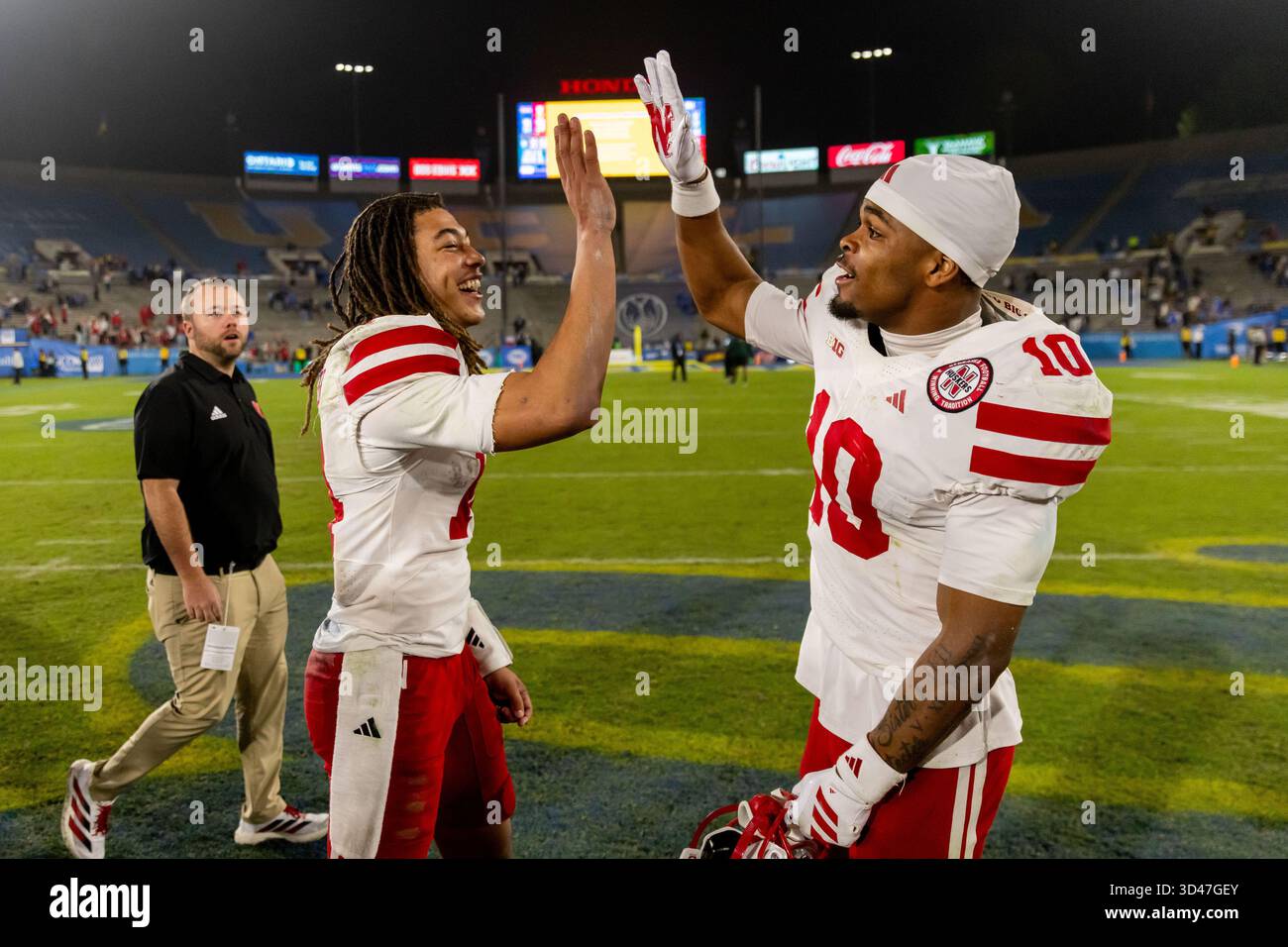 Nebraska quarterback TJ Lateef (14) and Nebraska defensive back Andrew ...