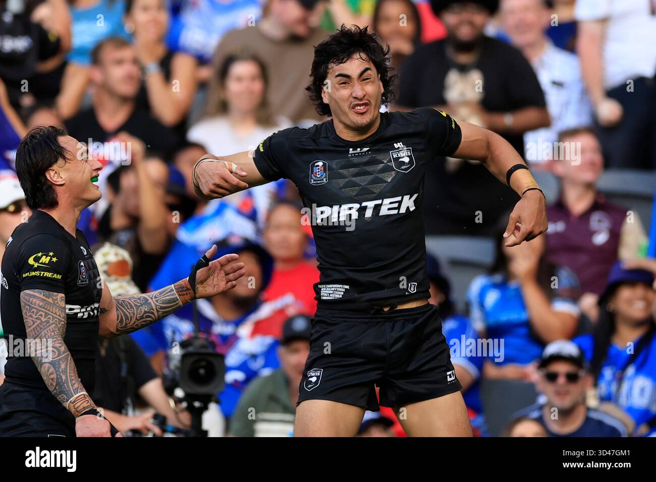 Casey McLean of the Kiwis celebrates scoring a try with team mates ...