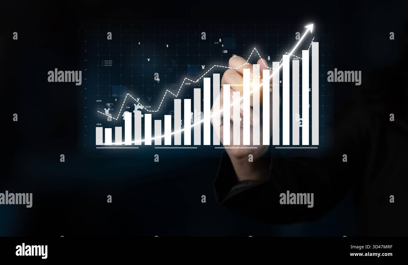 A businessman illustrates a growth chart with digital tools in a modern ...