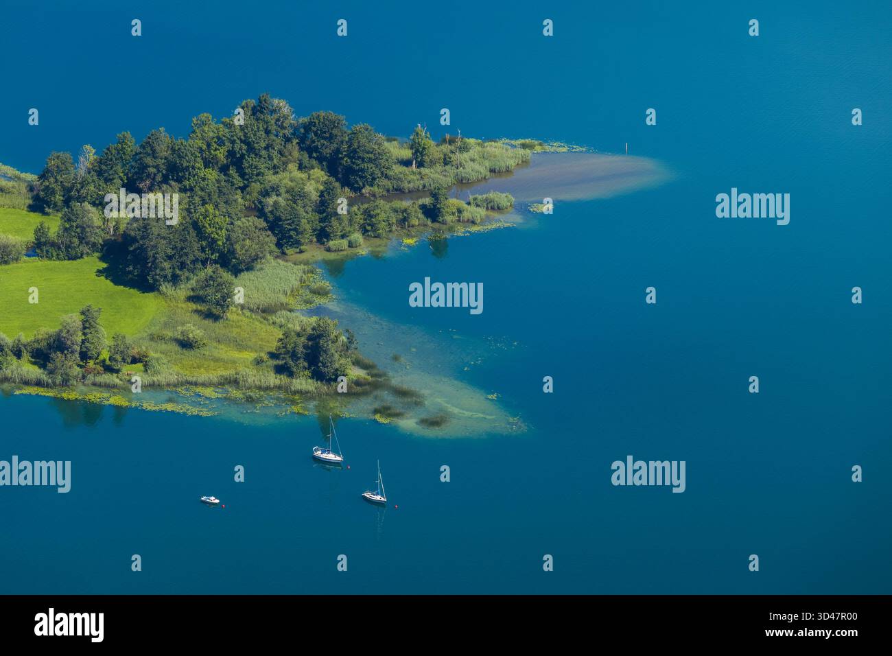 Aerial view to anchor yach ship on lake Mondsee with grass island ...