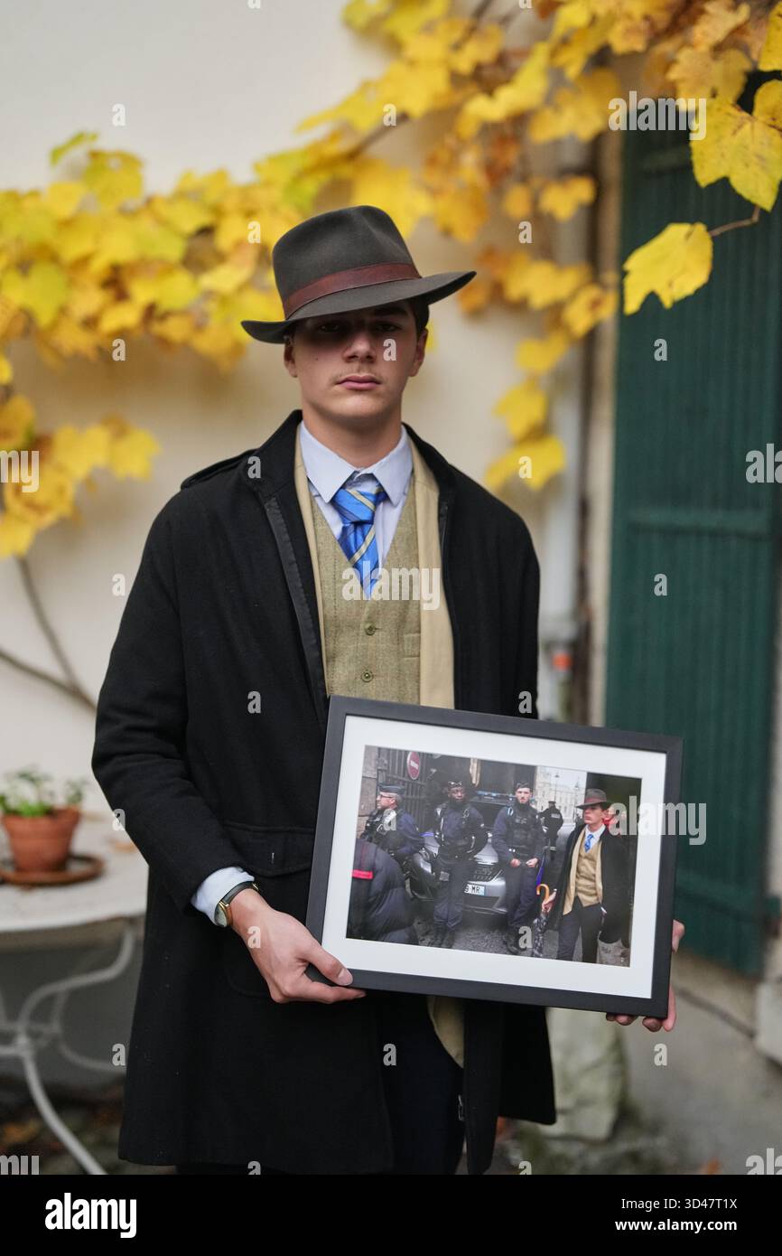 Pedro Elias Garzon Delvaux poses with an Associated Press photo of him ...