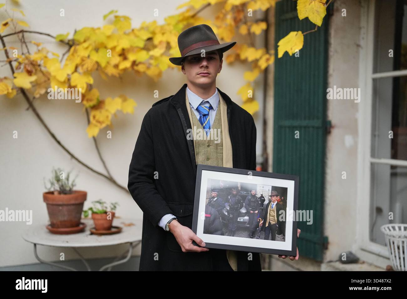 Pedro Elias Garzon Delvaux poses with an Associated Press photo of him ...