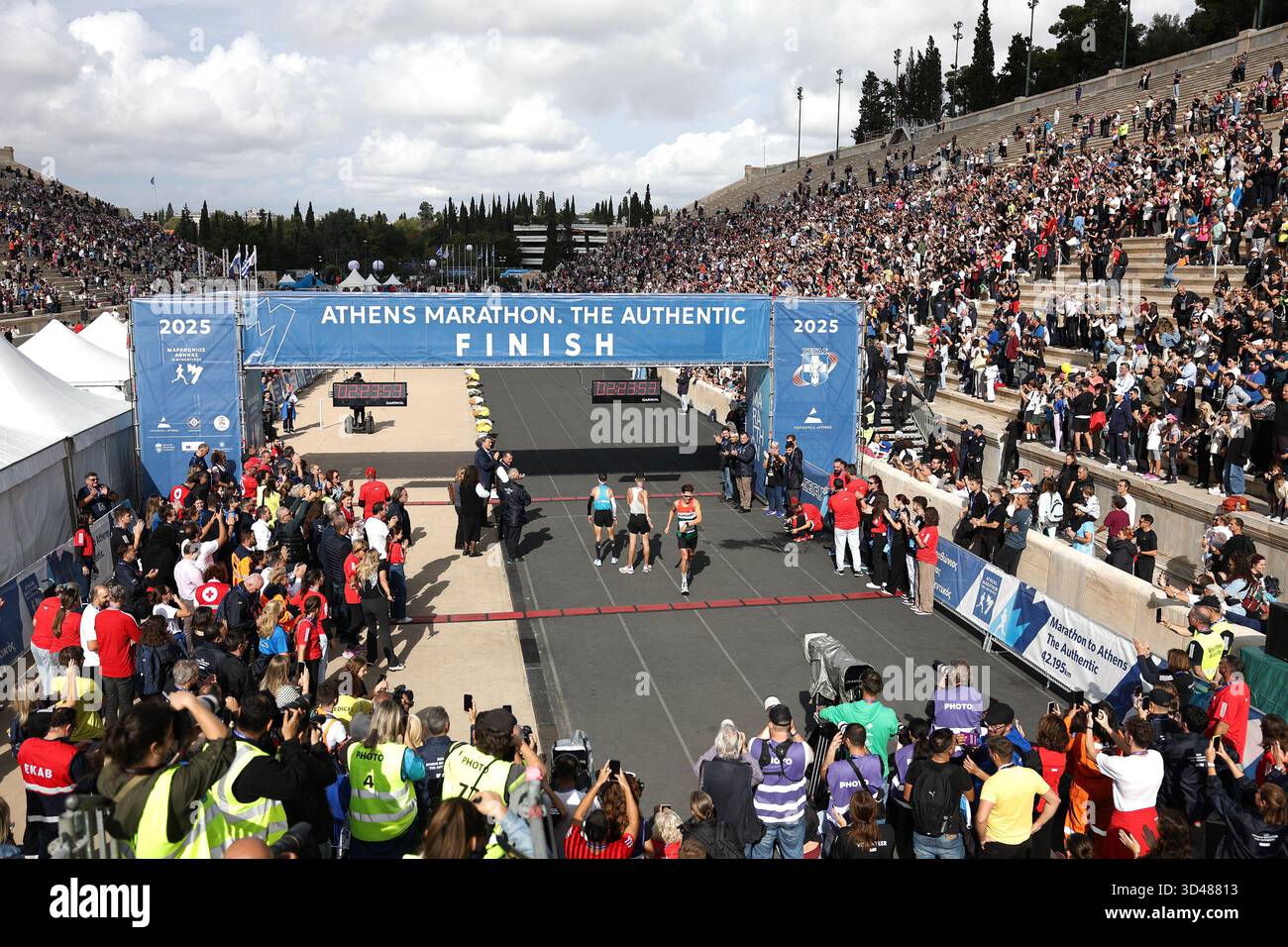 Marathon runners congratulate each other at the finish line of the 42nd ...