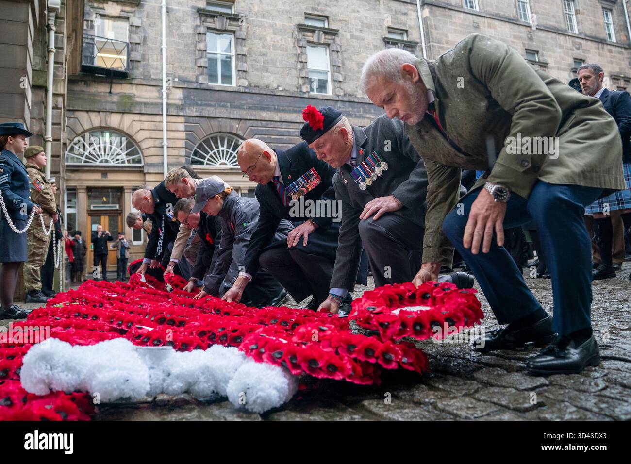 People lay wreaths during a Remembrance Sunday ceremony at the Stone of ...