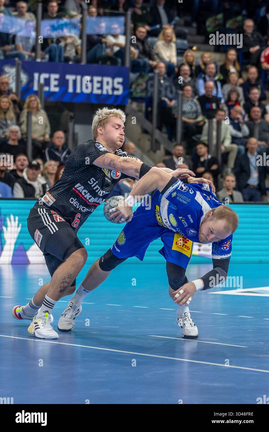 Peter Walz (ThSV Eisenach, #14) in a duel with Marek Nissen (HC Erlangen, #06). HC Erlangen vs ...