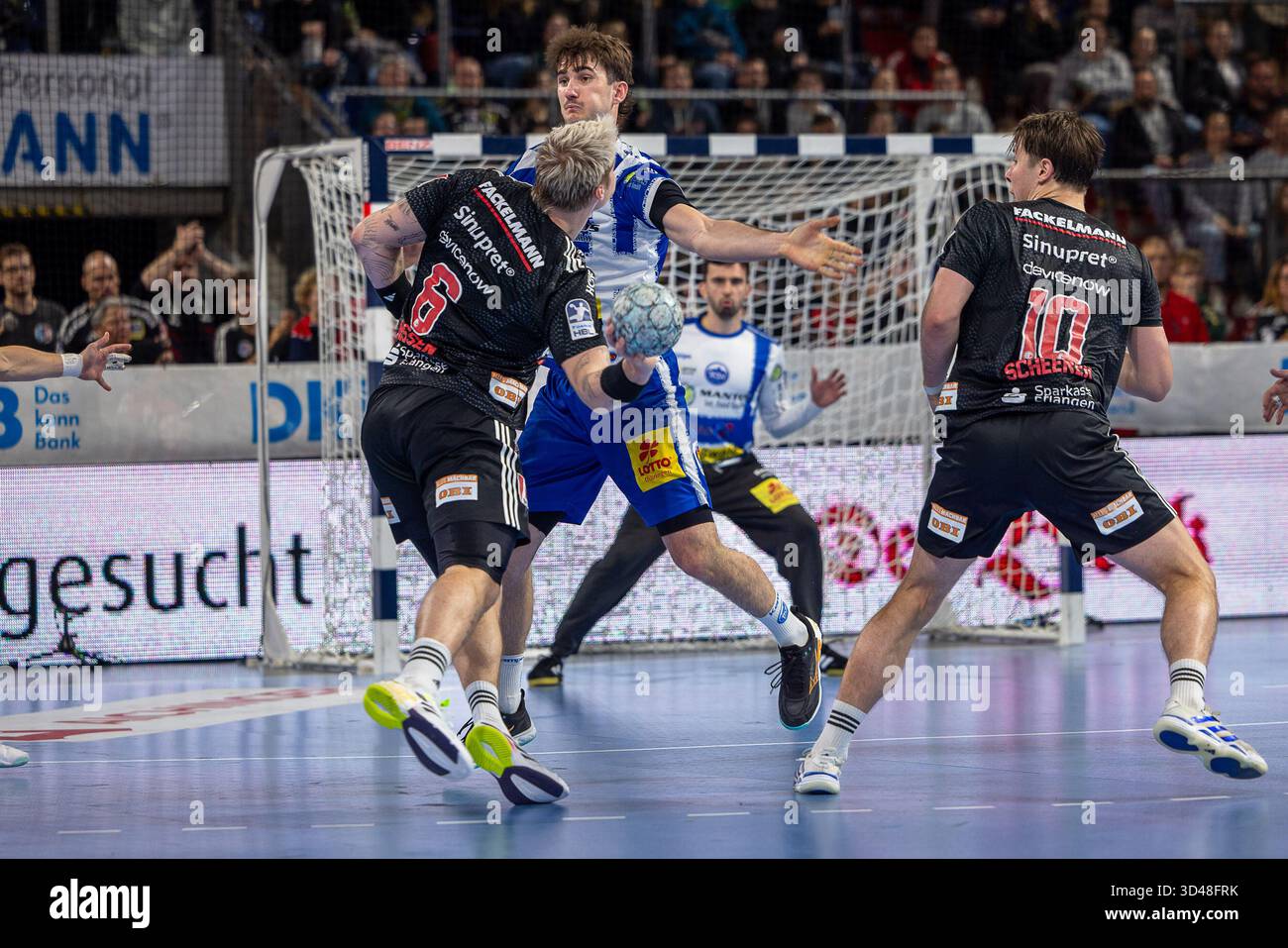 Marek Nissen (HC Erlangen, #06) during the throw around Stephan Seitz ...
