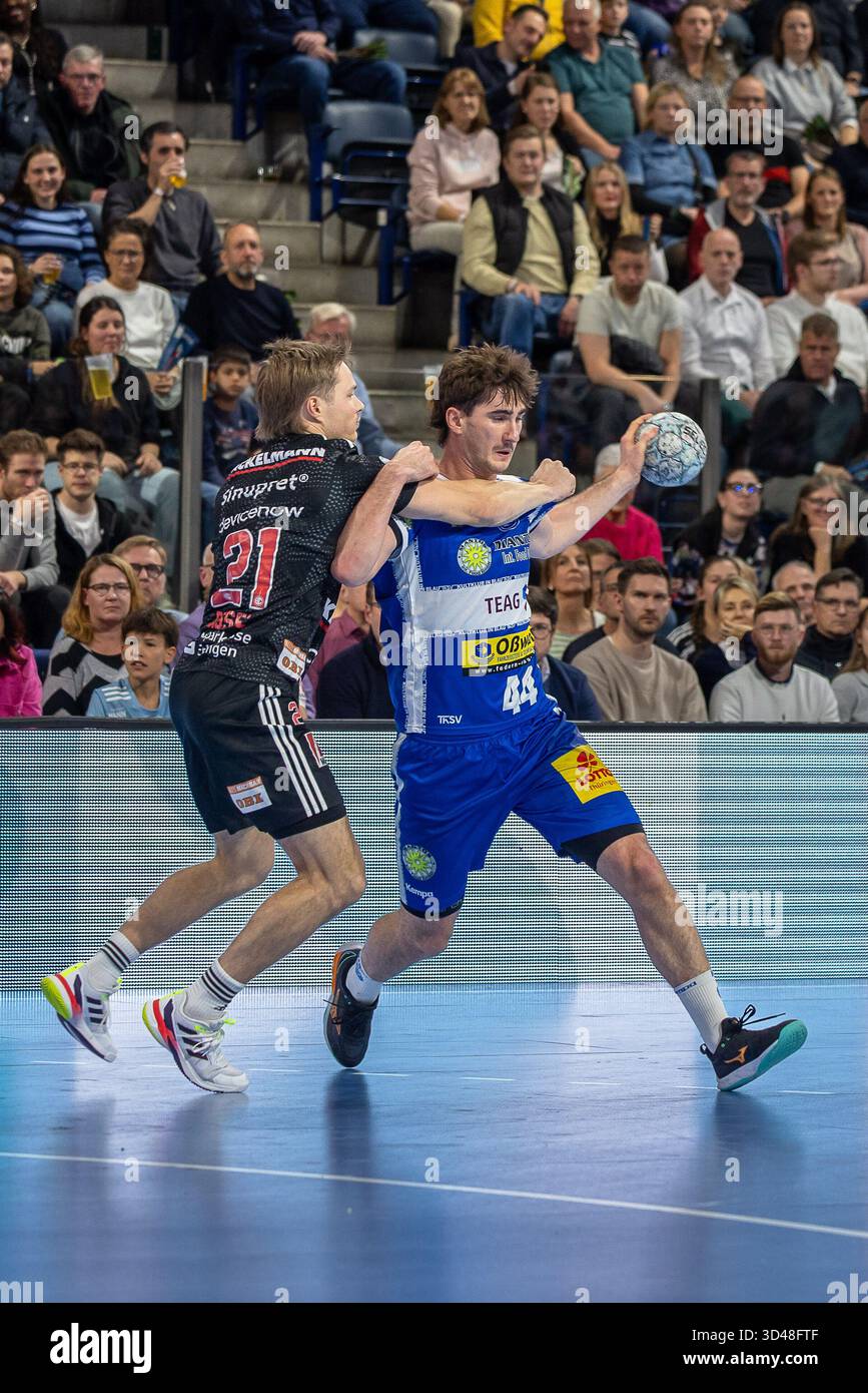 Christopher Bissel (HC Erlangen, #21) in a duel with Stephan Seitz (ThSV Eisenach, #44). HC ...