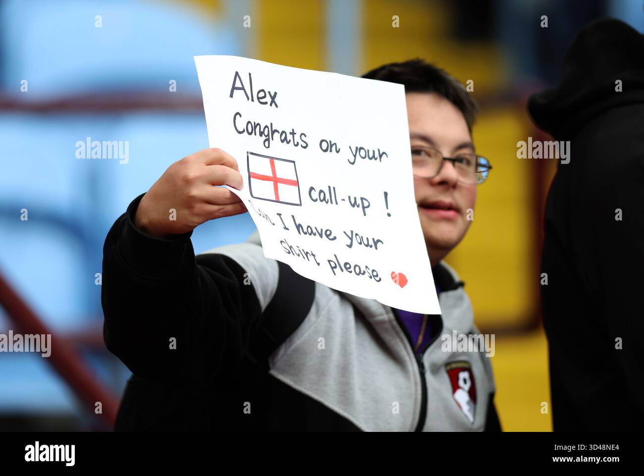 A Bournemouth fan with a sign asking for the shirt of Alex Scott before ...