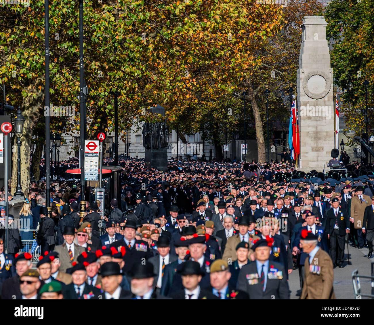 London, UK. 9 Nov 2025. A sea of veterans pass the two memorials - A ...