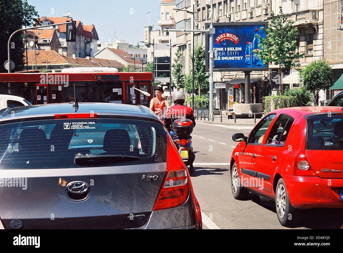 POV of driver at an intersection in Belgrade, red light, young man ...