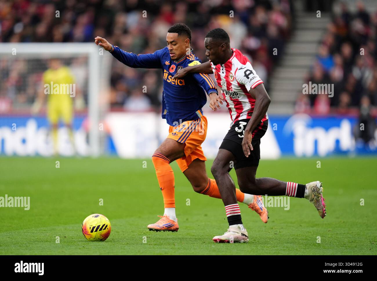 Newcastle United's Jacob Ramsey (left) and Brentford's Michael Kayode ...