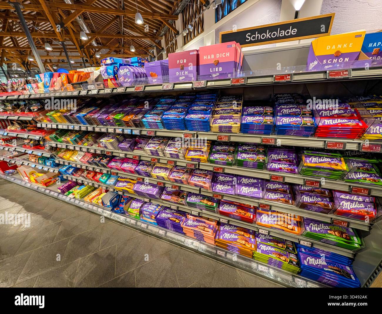 Supermarket Aisle With Rows Of Chocolate Bars, Mainly Milka, Under A ...