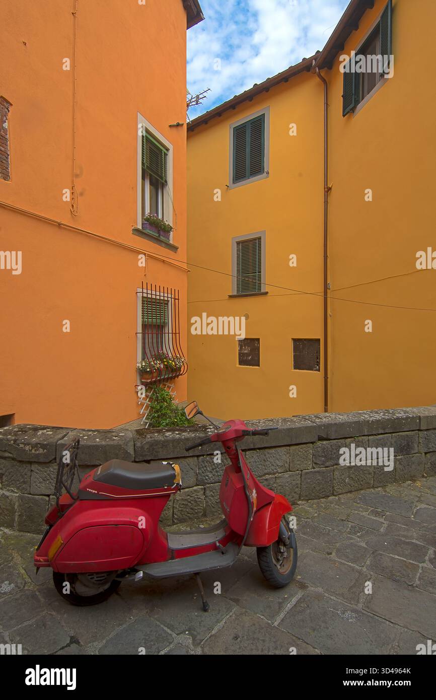 Scenes from a small town, Lucca in Tuscany, Italy wth a red Vespa and ...