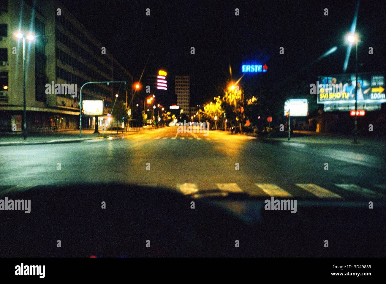 Driver’s view of an empty intersection in downtown Novi Sad at night ...