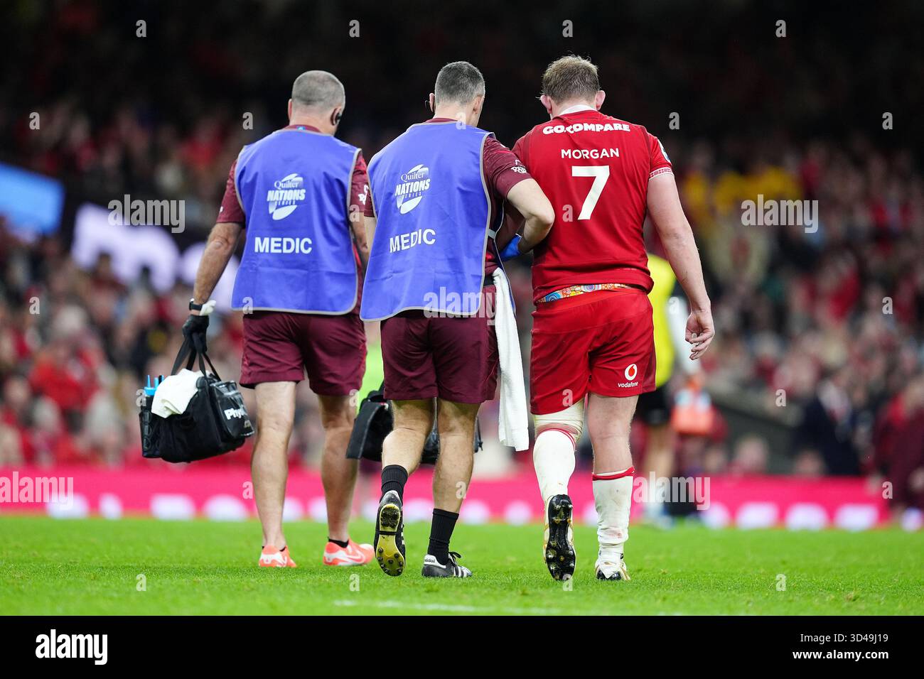 Wales' Jac Morgan (right) leaves the field after getting injured ...