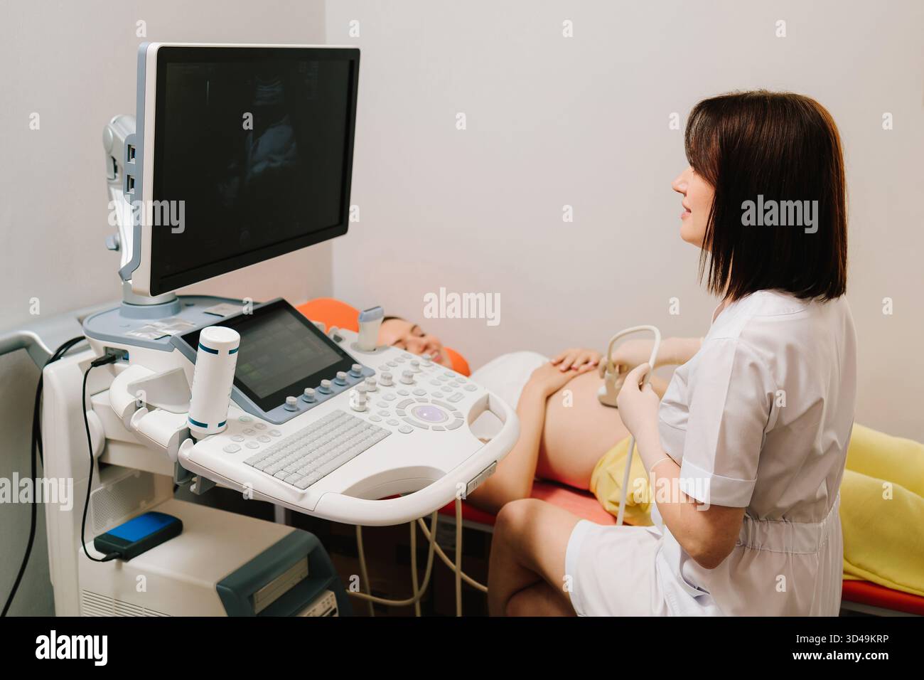 Checking fetus health at the gynecology hospital. Gynecologist uses ...