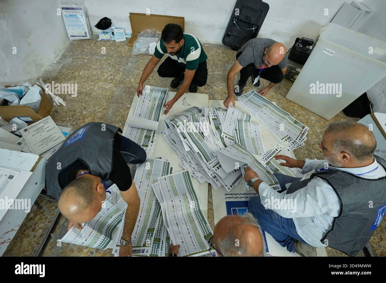 Election workers count ballots at the end of a special voting session ...
