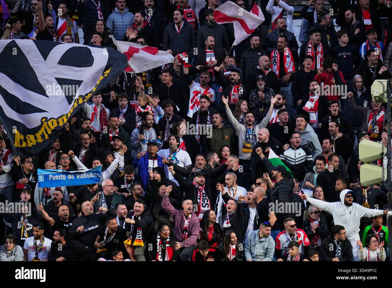Fans react as they watch a Spanish La Liga soccer match between Rayo Vallecano and Real Madrid ...