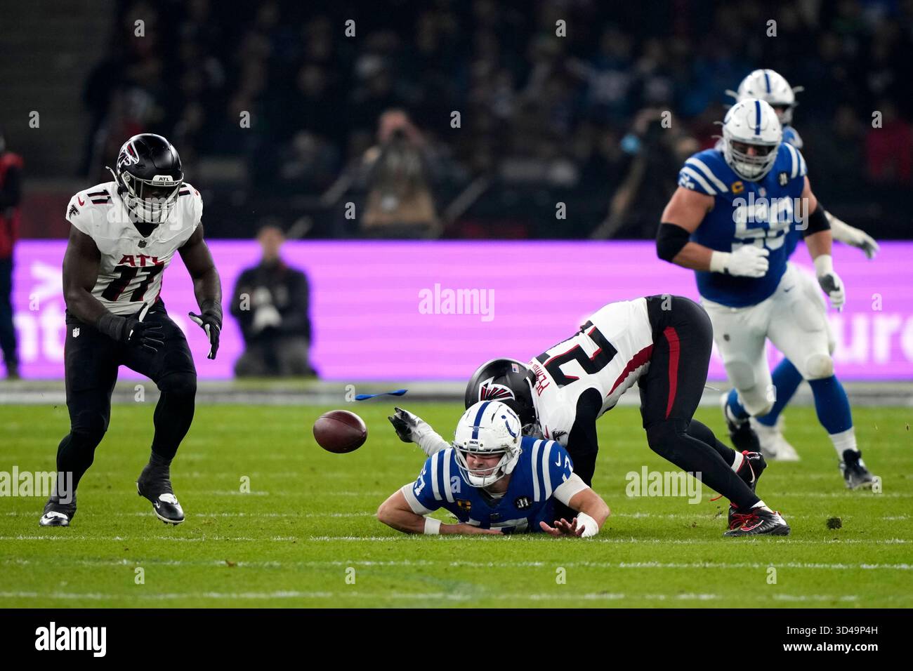 Indianapolis Colts quarterback Daniel Jones (17) fumbles as he is hit ...
