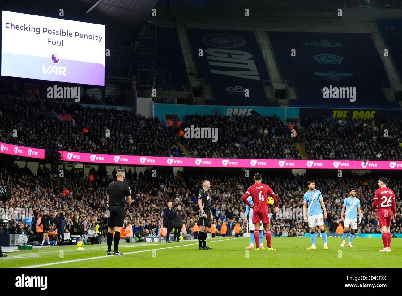 The players and officials wait while a VAR checks for a possible ...