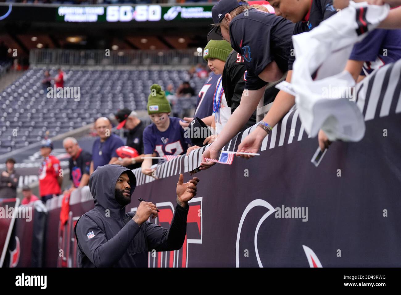 Houston Texans wide receiver Nico Collins (12) signs autographs before ...