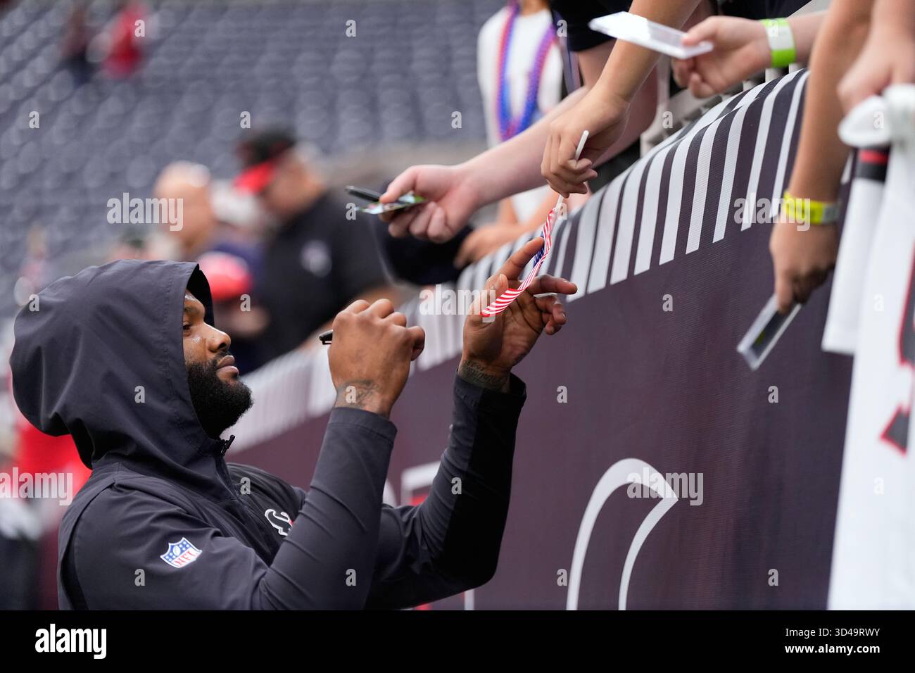 Houston Texans wide receiver Nico Collins (12) signs autographs before ...