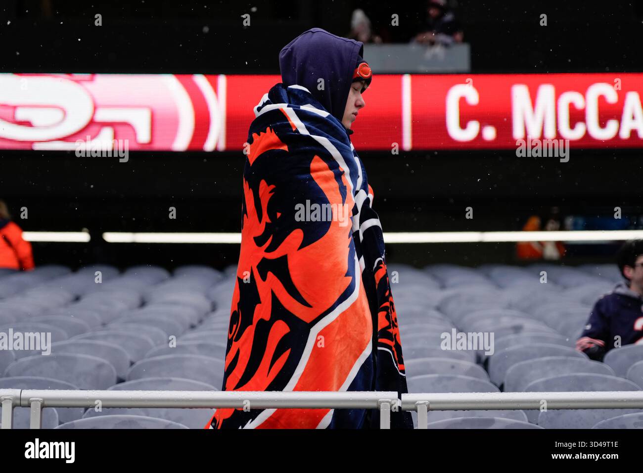 A Chicago Bears fan warms up before an NFL football game against the ...