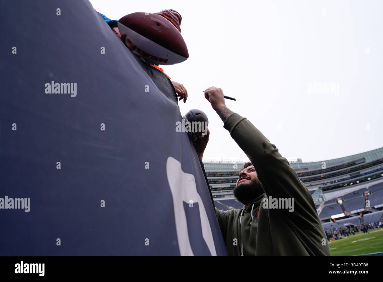 Chicago Bears guard Jonah Jackson signs autographs for fans before an ...
