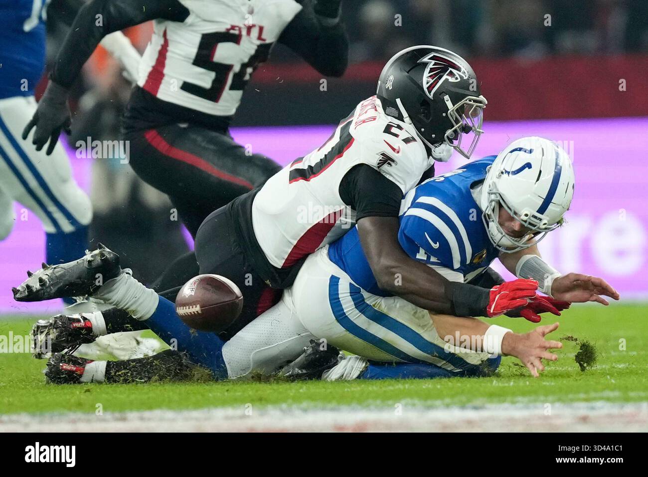 Indianapolis Colts quarterback Daniel Jones fumbles as he is hit by ...
